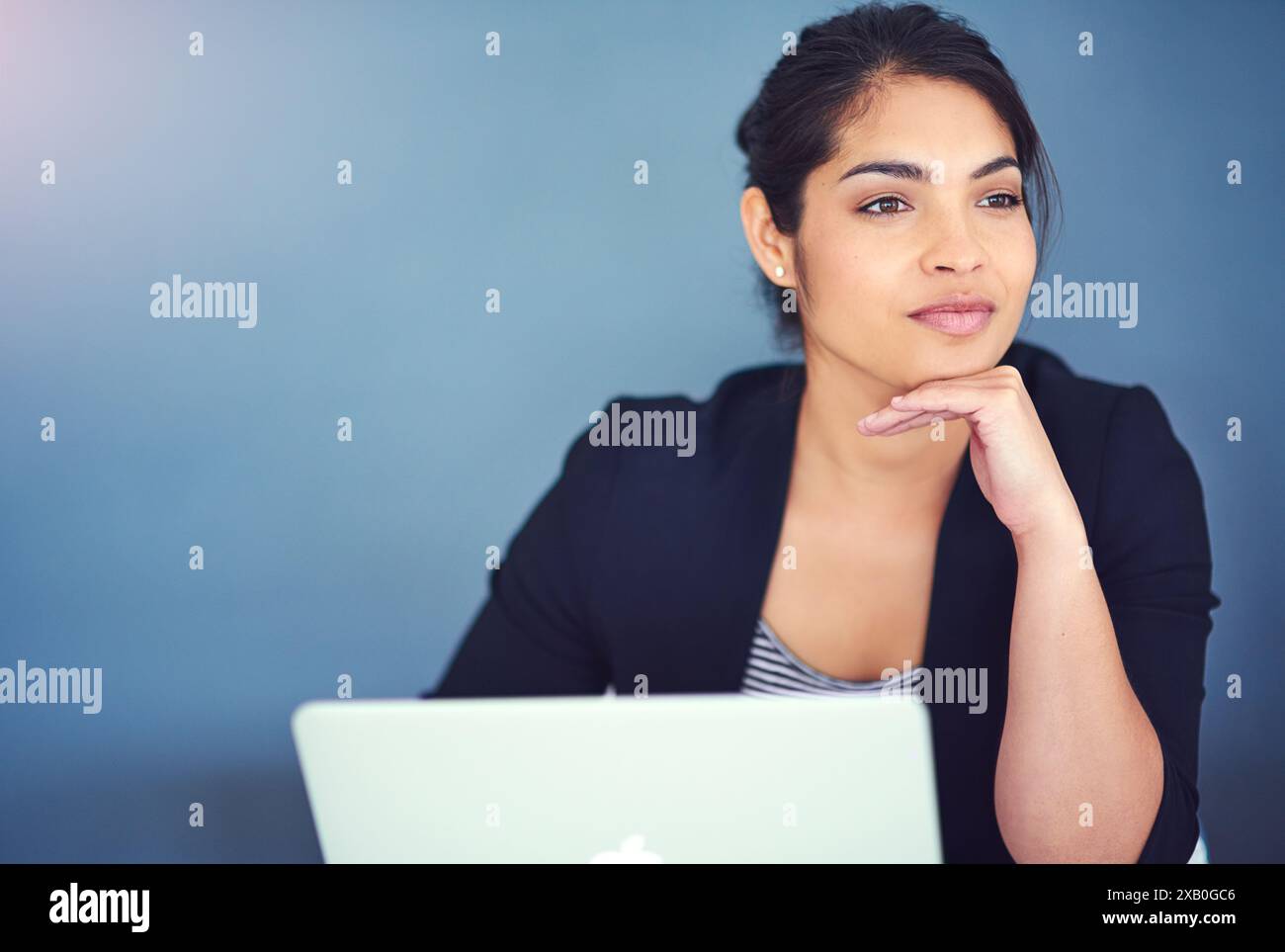 Business woman, thinking and planning on laptop with ideas ...