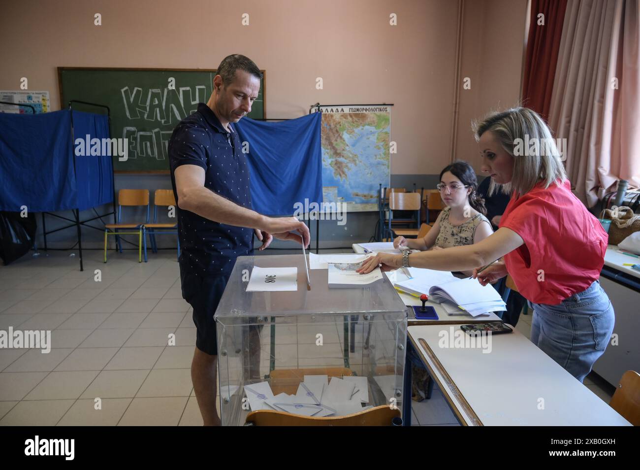 Athens, Greece. 9 June 2024. A voter casts his ballot at a polling ...