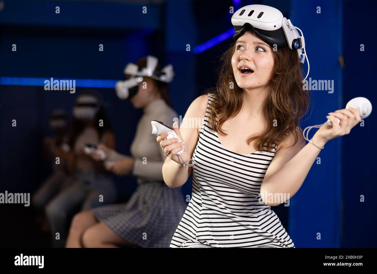 Girl gamer with virtual reality glasses on her forehead expresses ...