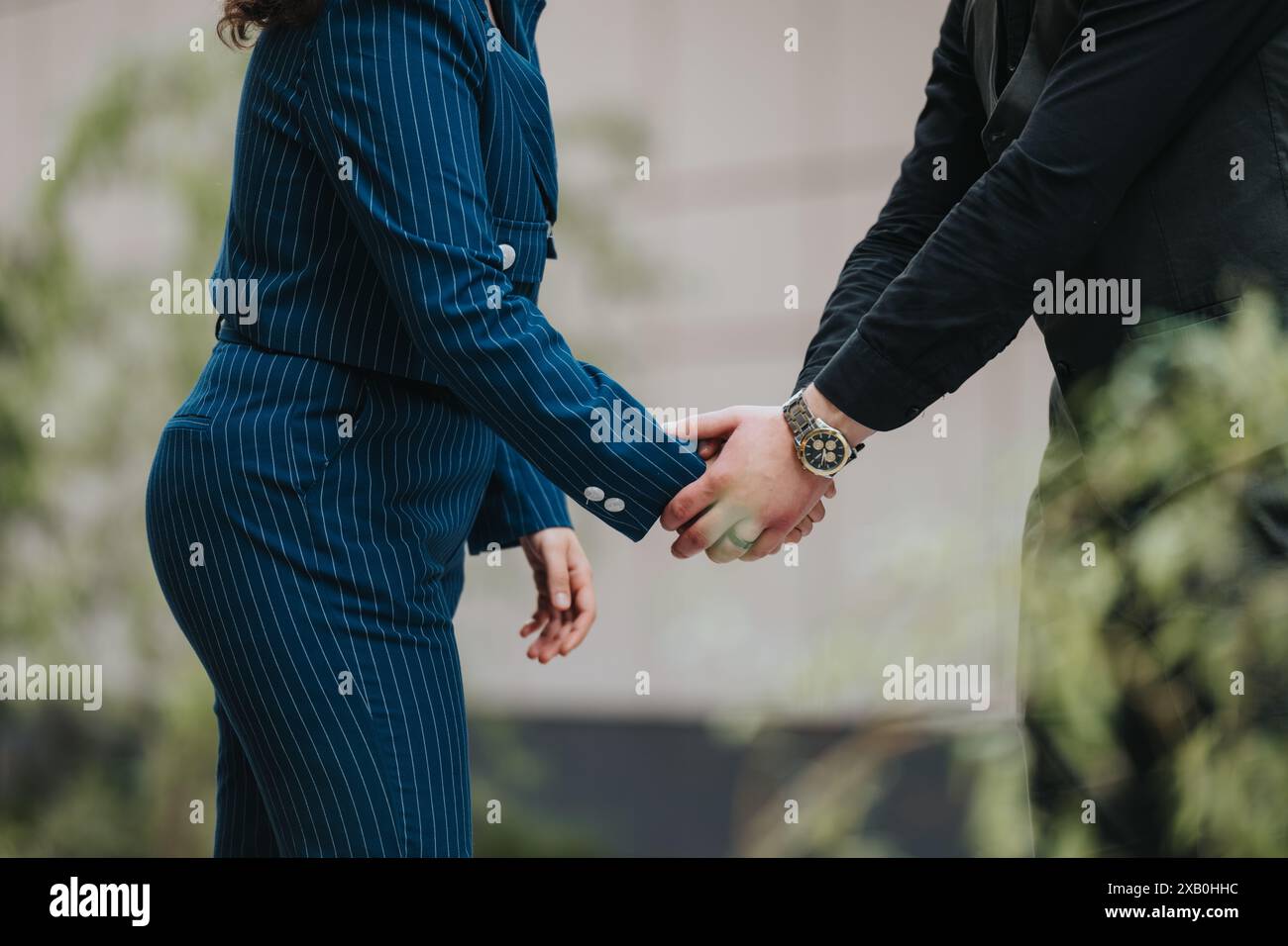 Business handshake between professionals wearing formal attire outside ...