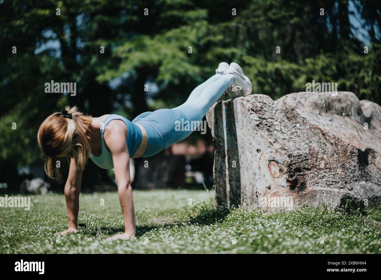 Woman performing outdoor calisthenics hi-res stock photography and ...