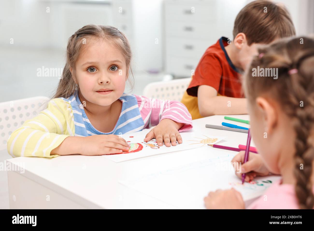 Group of children drawing at table indoors Stock Photo - Alamy
