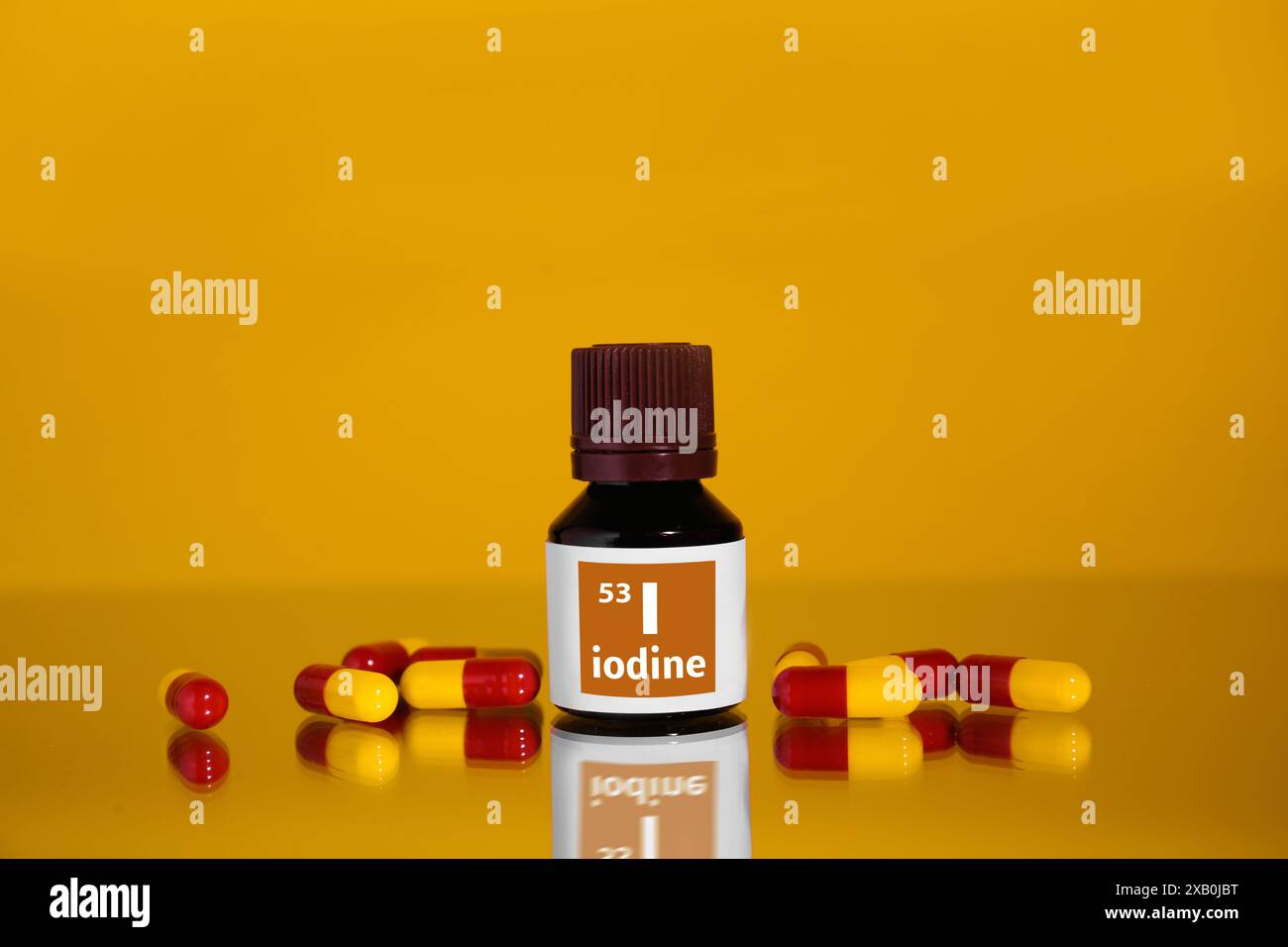 Bottle of medical iodine and pills on orange background Stock Photo - Alamy