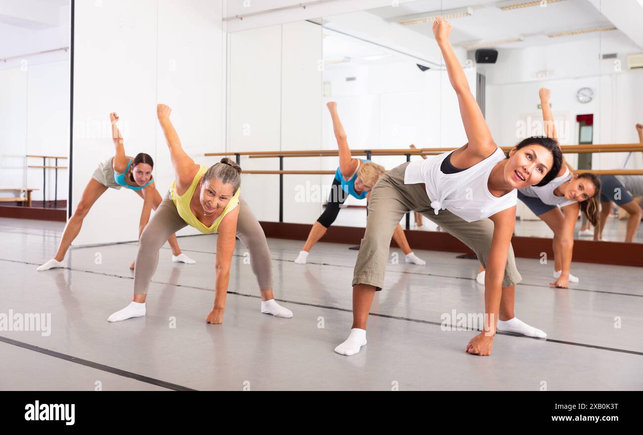 Group of dancers exercising modern dance movements in ball room Stock ...