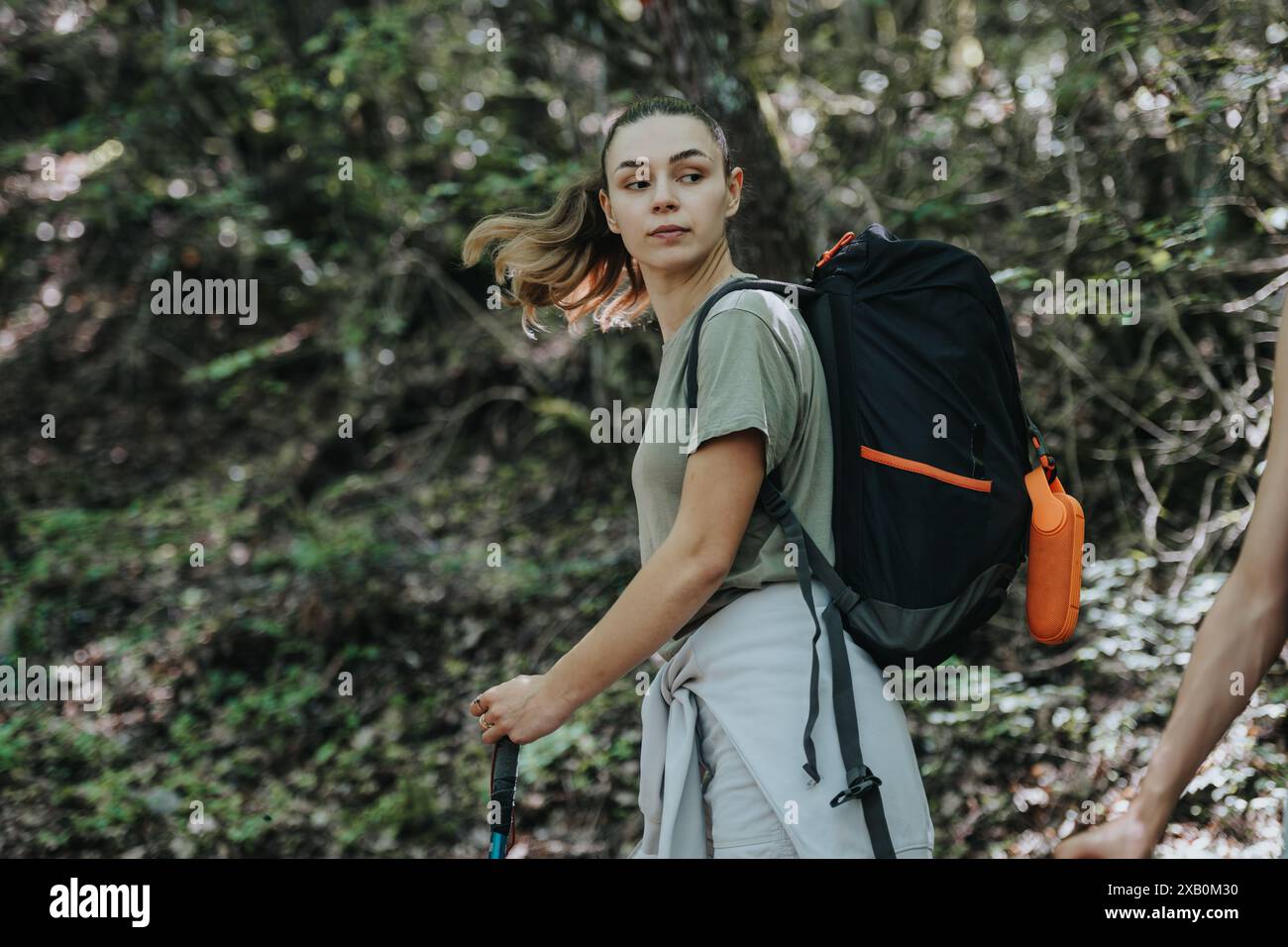 Woman hiking in nature, exploring mountains with a backpack Stock Photo ...