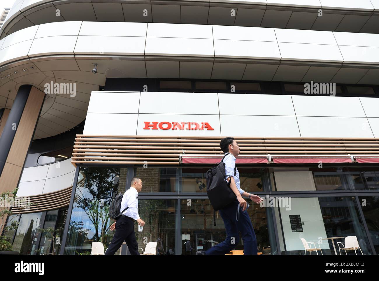 A photo shows HONDA MOTOR CO.,LTD. headquarters' building in Minato ...