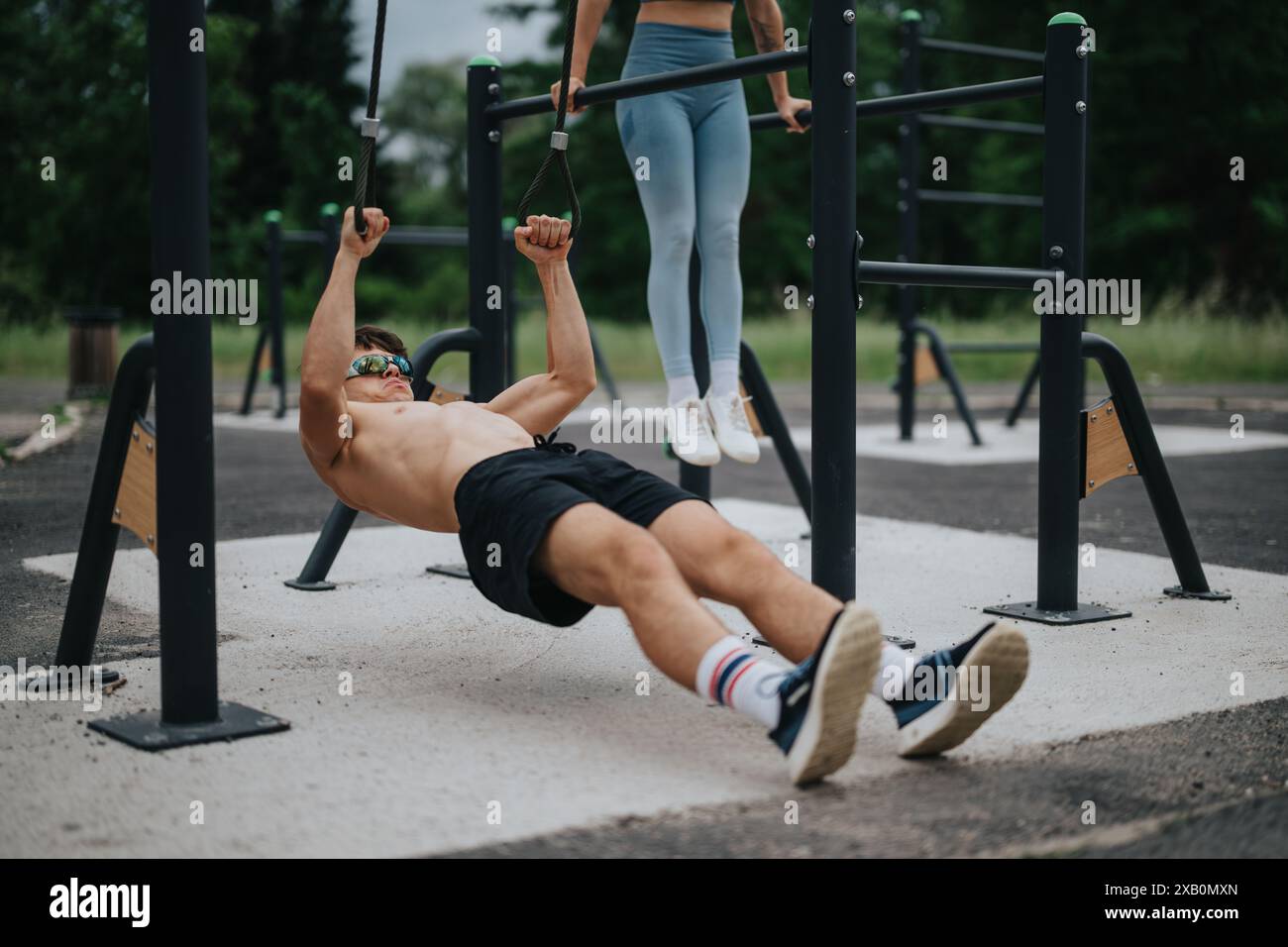 Outdoor Calisthenics Workout With A Man And Woman Performing Exercises