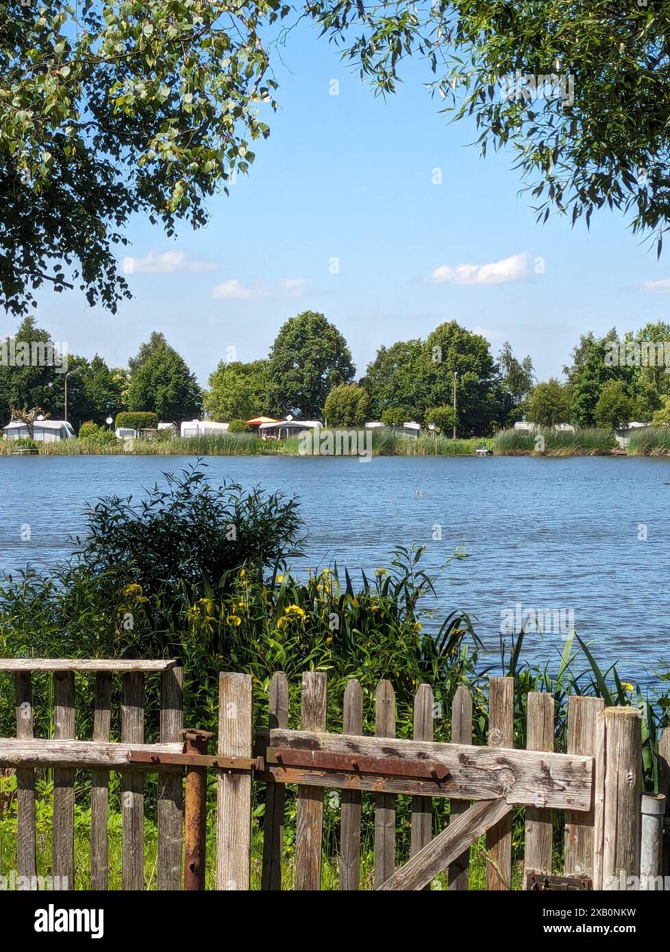 Camping area on pond Stock Photo - Alamy