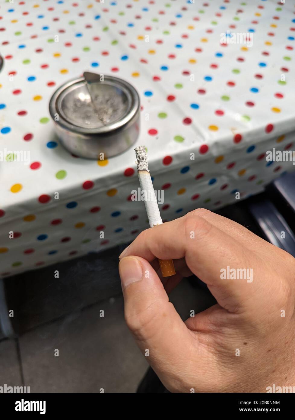 Smoking hand, with ashtray Stock Photo - Alamy