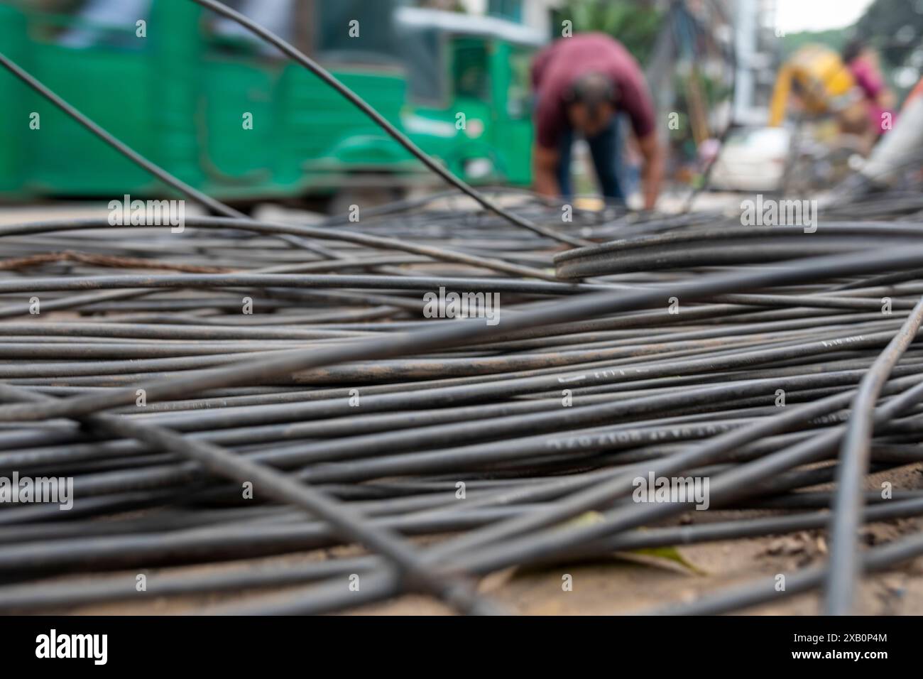 Workers repairing overhead internet cables damaged by a storm in Dhaka ...