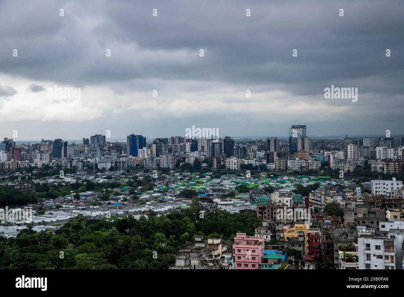 aerial view of densely Dhaka’s Korail Slum and Gulshan-Banani area under a cloudy sky ...