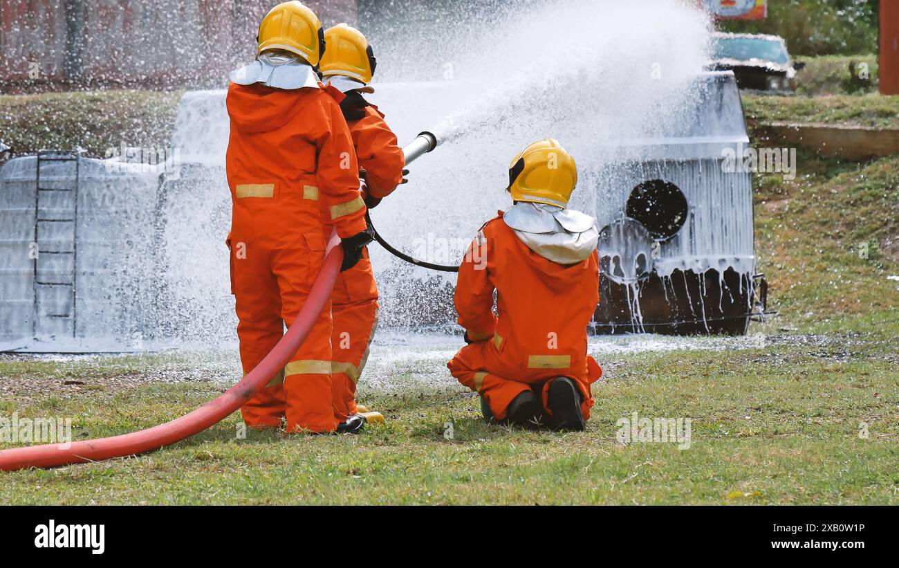 Firefighter fighting with flame using fire hose chemical water foam ...