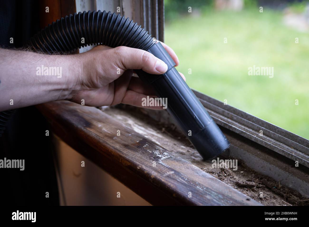 Cleaning debris out of window ledge and grooves with vacuum Stock Photo ...
