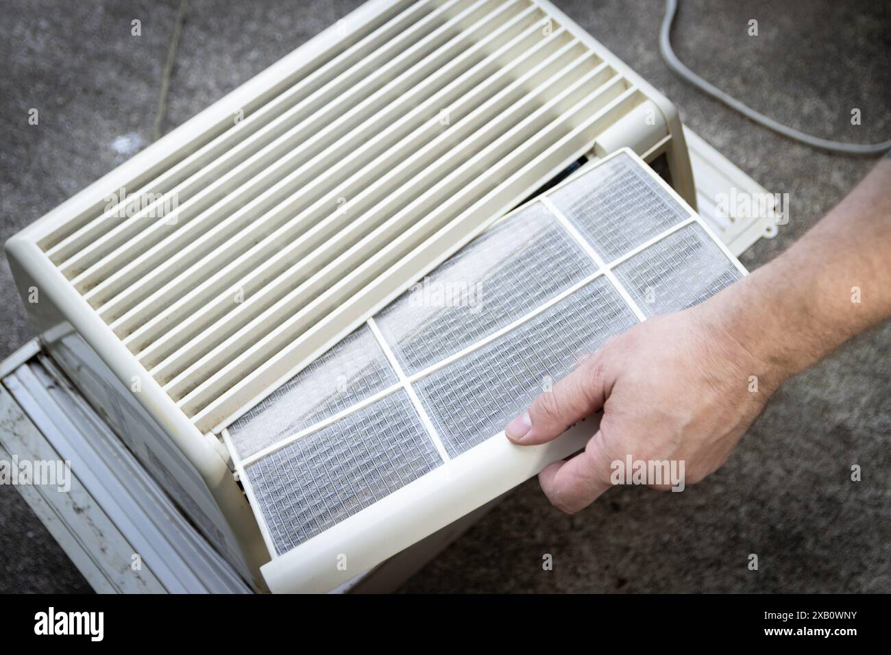 Removing air filter from window air conditioner unit Stock Photo - Alamy