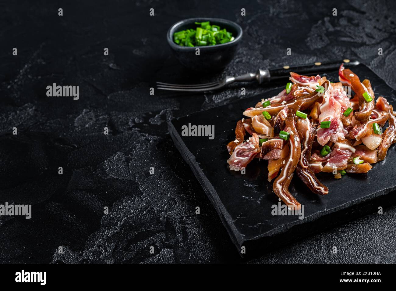Fried pig ears with sesame seeds and green onions. Fried pork ears in ...