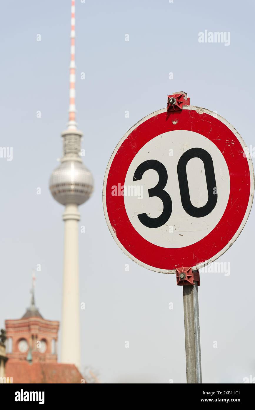 Traffic sign with the 30 km/h speed limit in Berlin with the television tower in the background ...