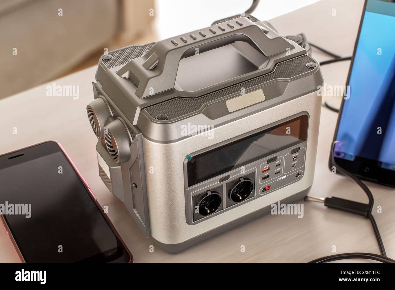 One universal electric battery, a portable charging station stands on a ...