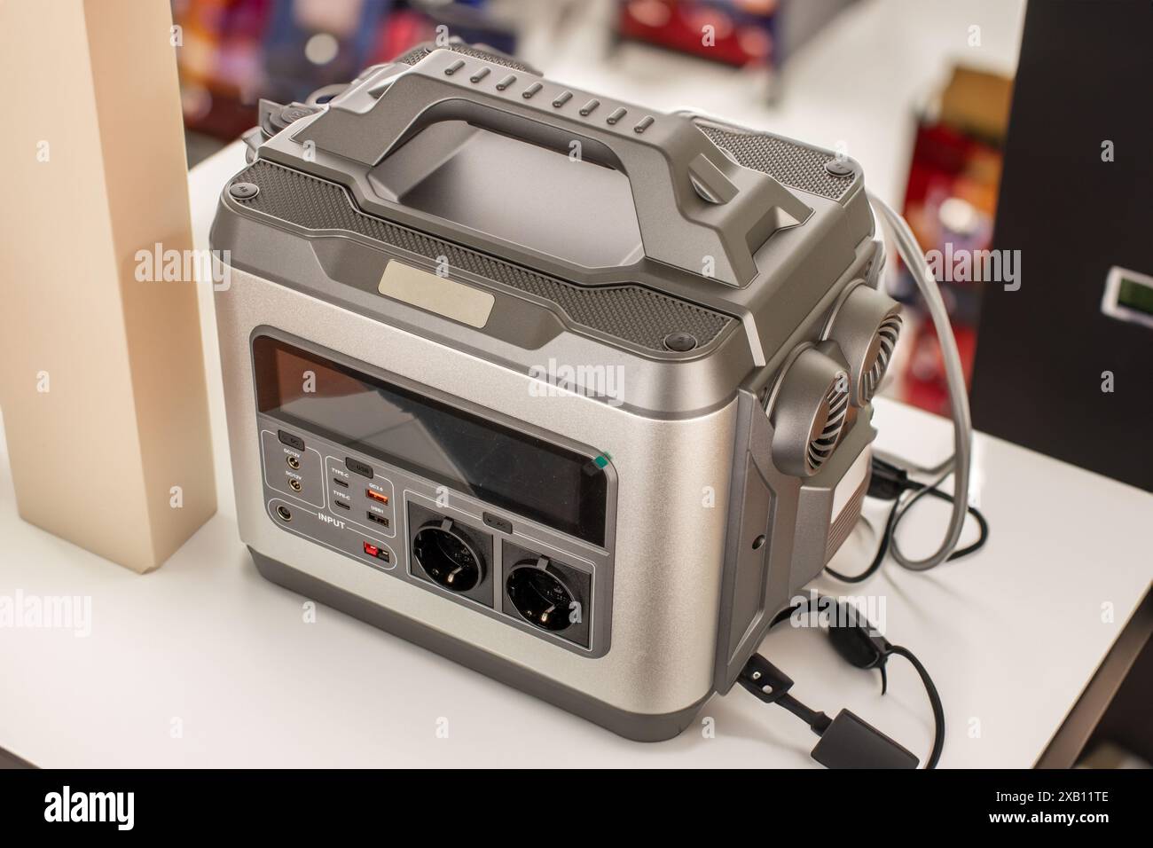 One universal electric battery, a portable charging station stands on a ...