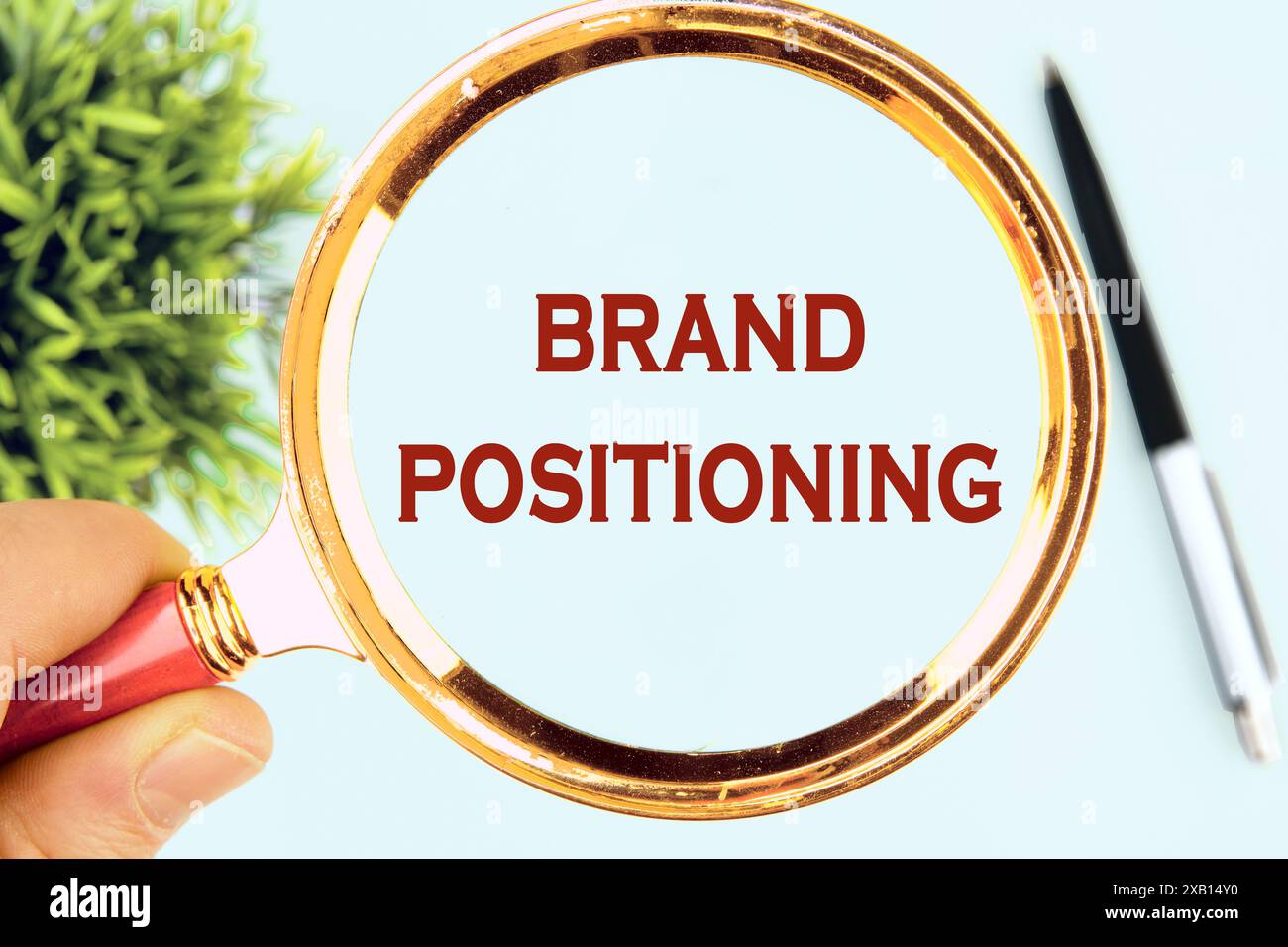 Business branding concept. BRAND POSITIONING text written through a ...