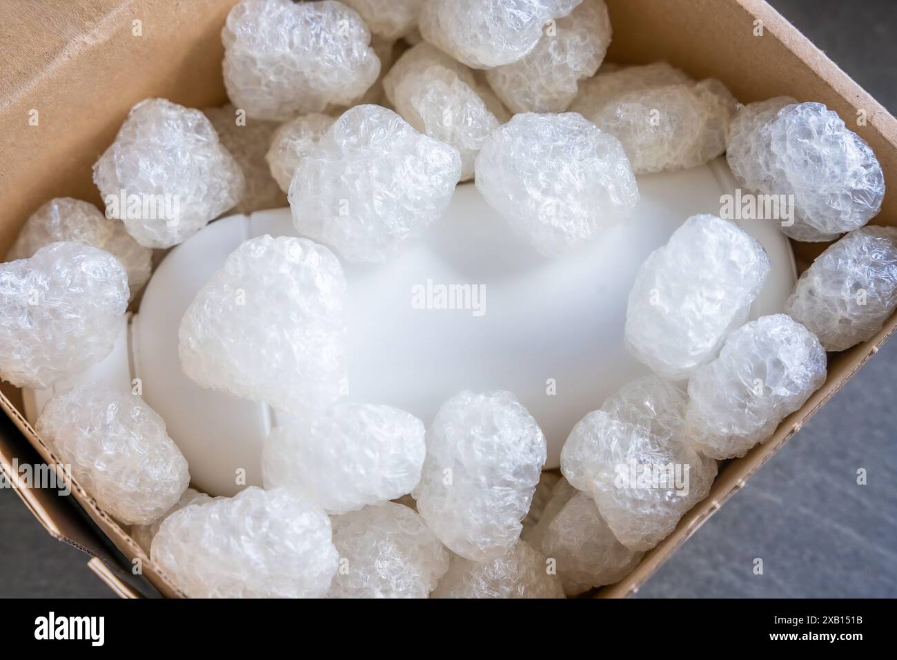 Eco packaging of parcels and white biodegradable filler. Box is filled ...