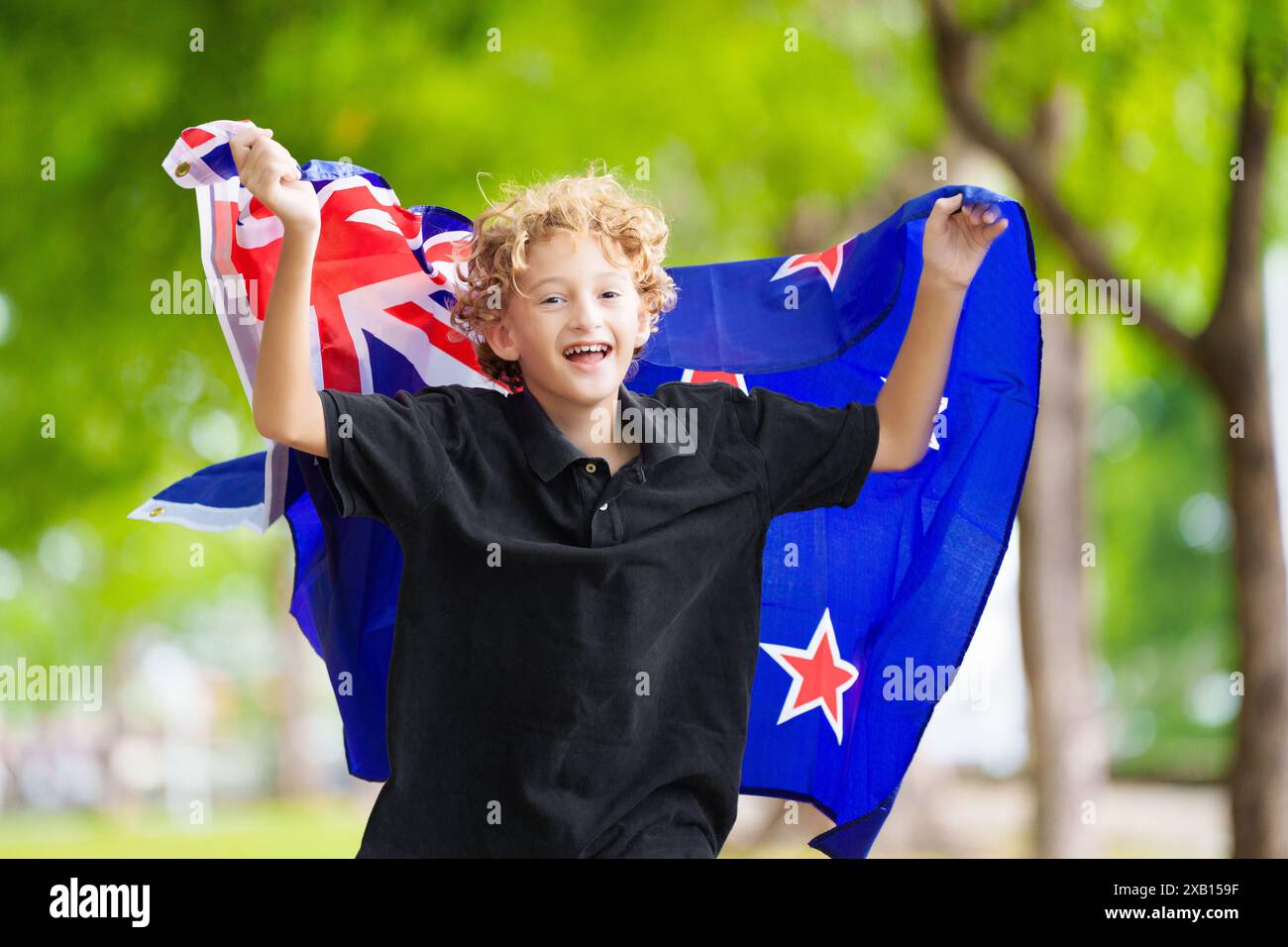 Child running with New Zealand flag. Little New Zealander boy cheering ...