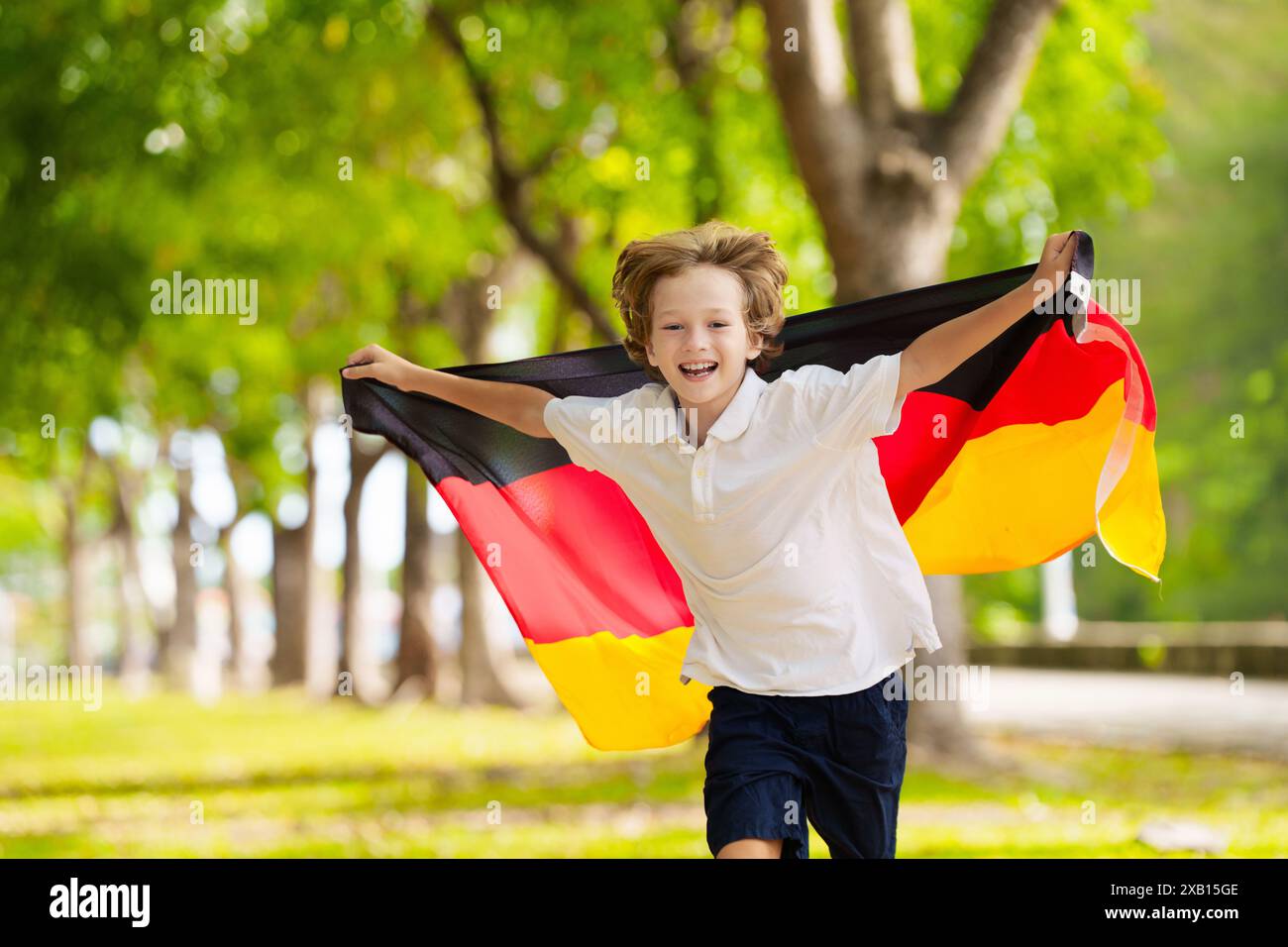 Child running with Germany flag. Little German boy cheering for country ...