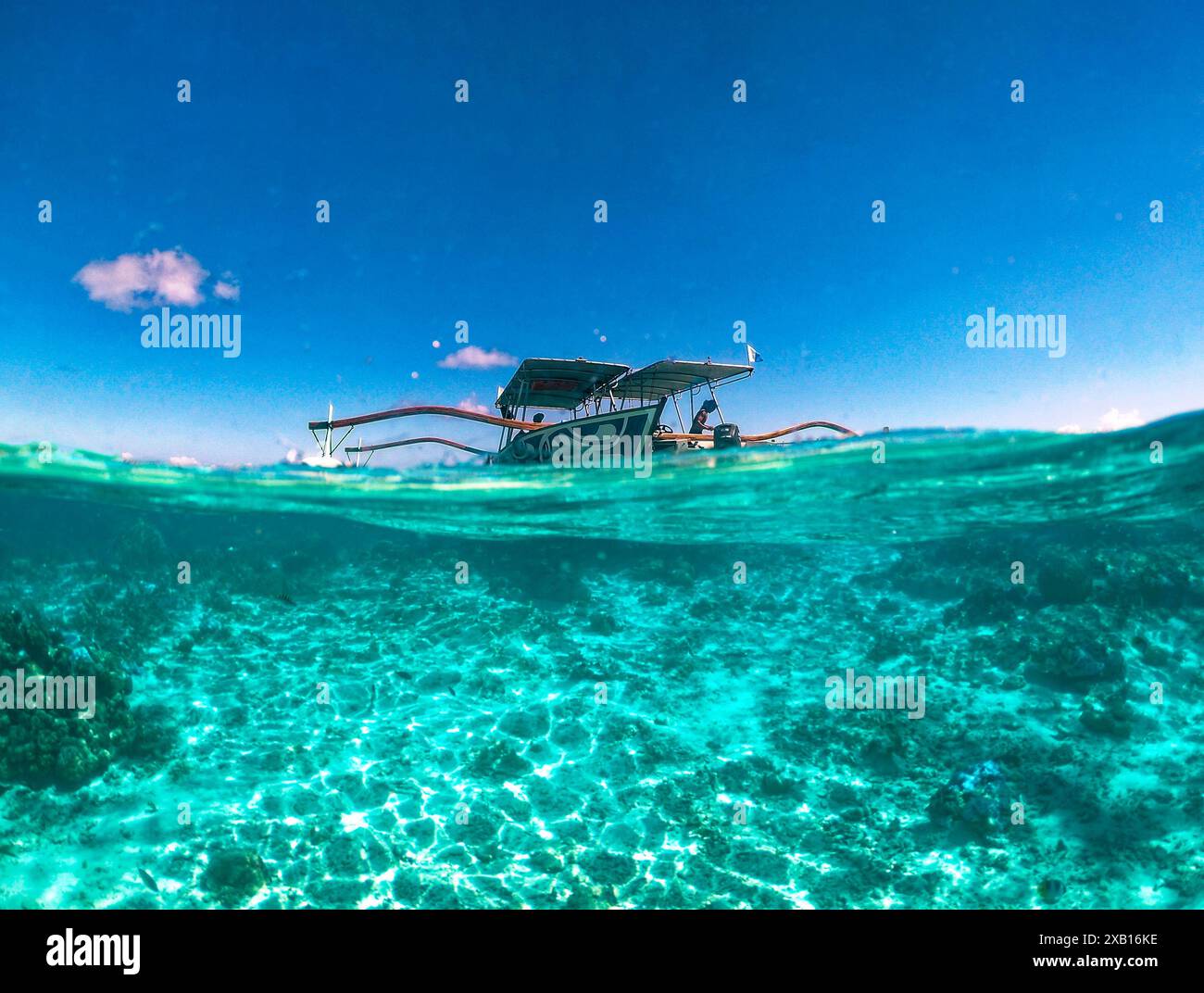 Half-in Half-out view of a traditional Polynesian canoe on a turquoise ...