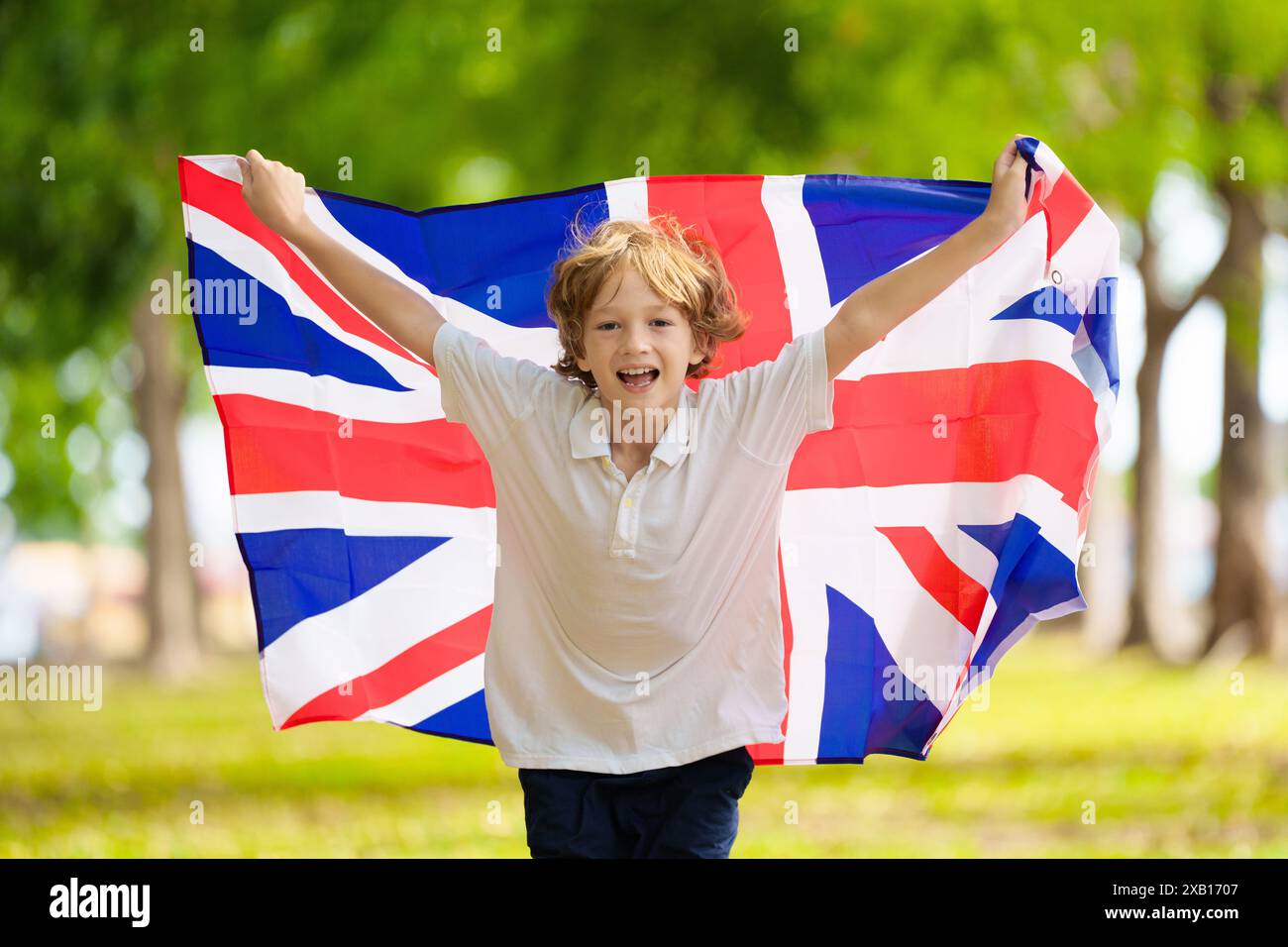 Child running with UK flag. British supporter. Little Britain fan kid ...