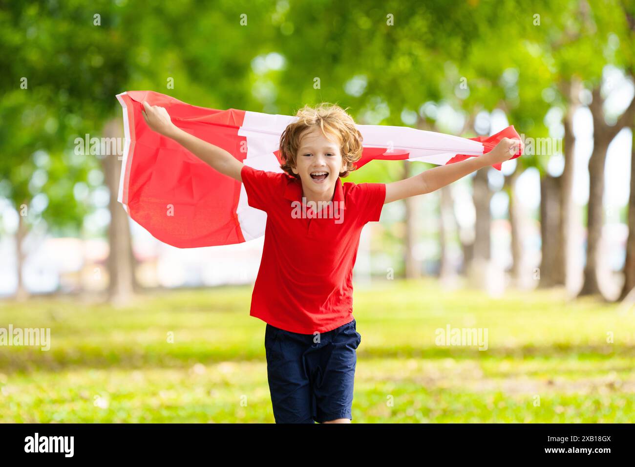 Child with Canadian flag. Happy Canada day. Little boy running with ...