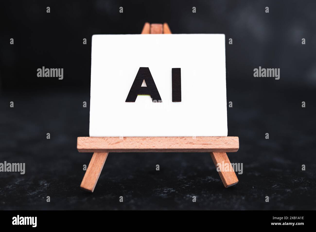 AI text on miniature canvas on easel on dark background with fairy ...