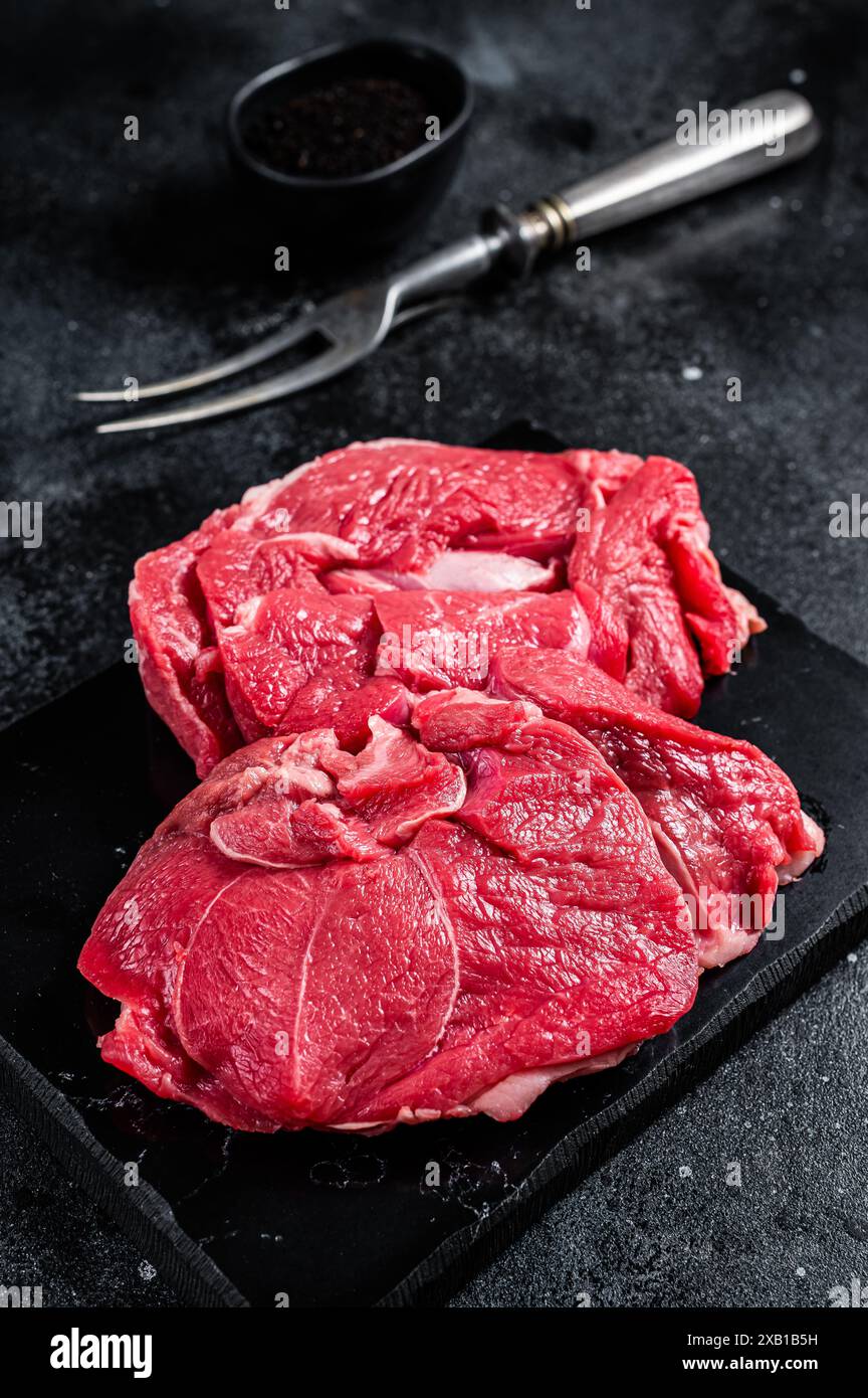 Raw Mutton fillet steaks from leg, uncooked lamb meat. Black background ...