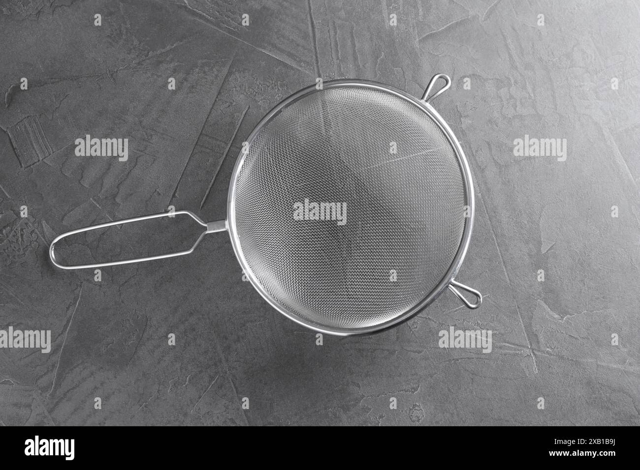 One metal sieve on grey table, top view Stock Photo - Alamy
