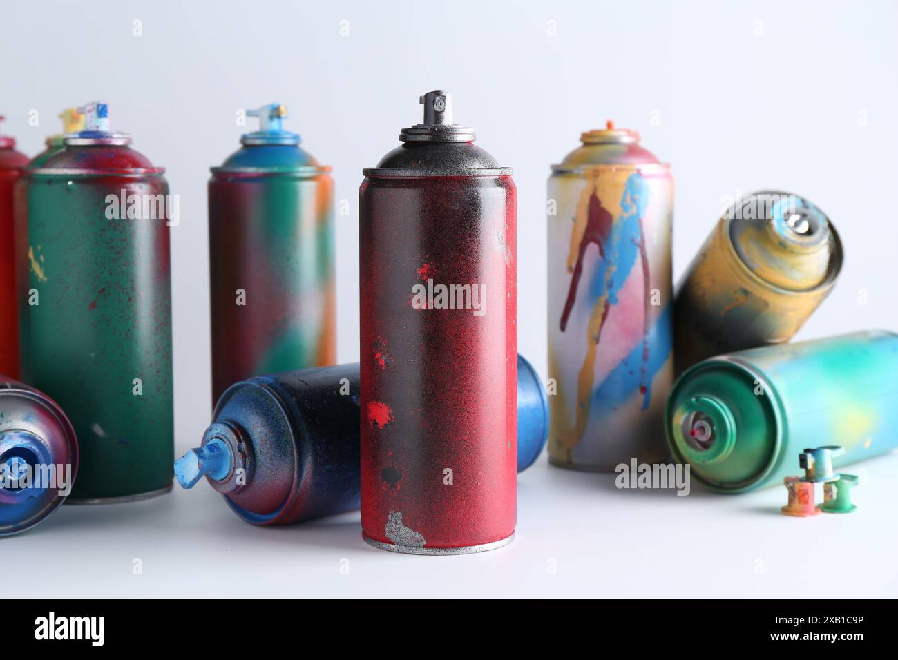 Many spray paint cans on white background Stock Photo - Alamy
