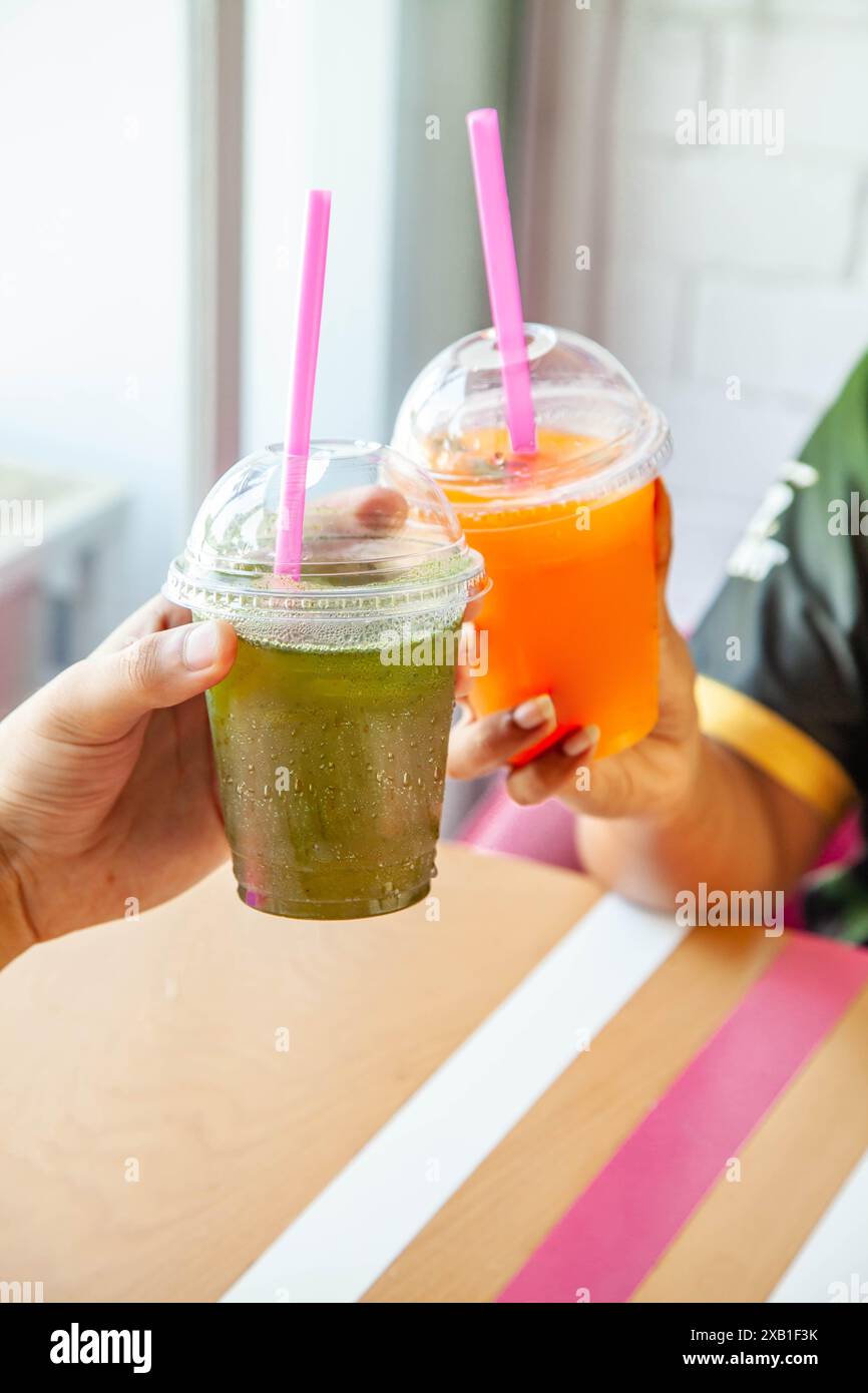 Slushes and cooler drinks in hands of people giving cheers inside a ...
