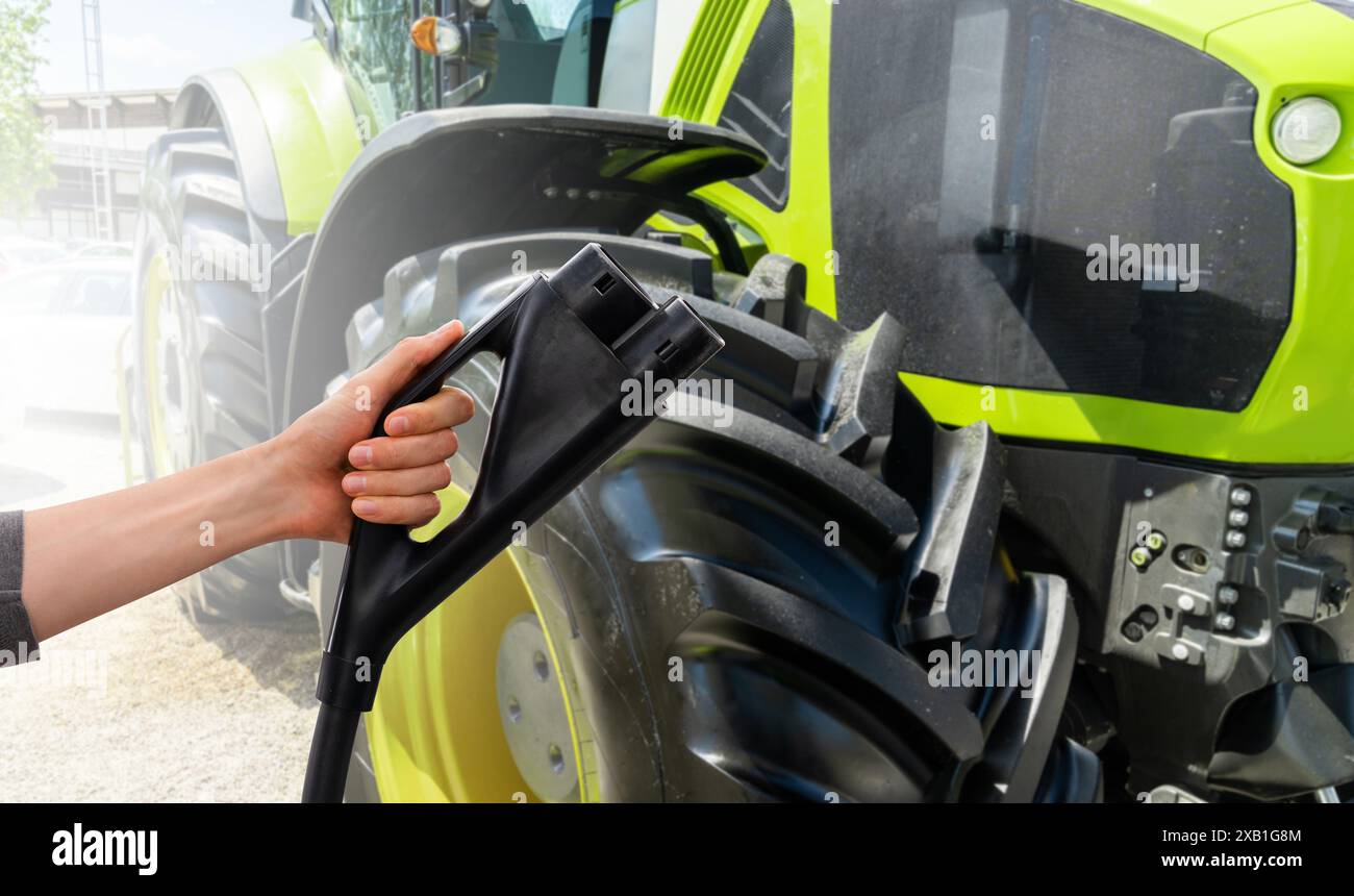 Hand with electric vehicles charging plug on a background of ...