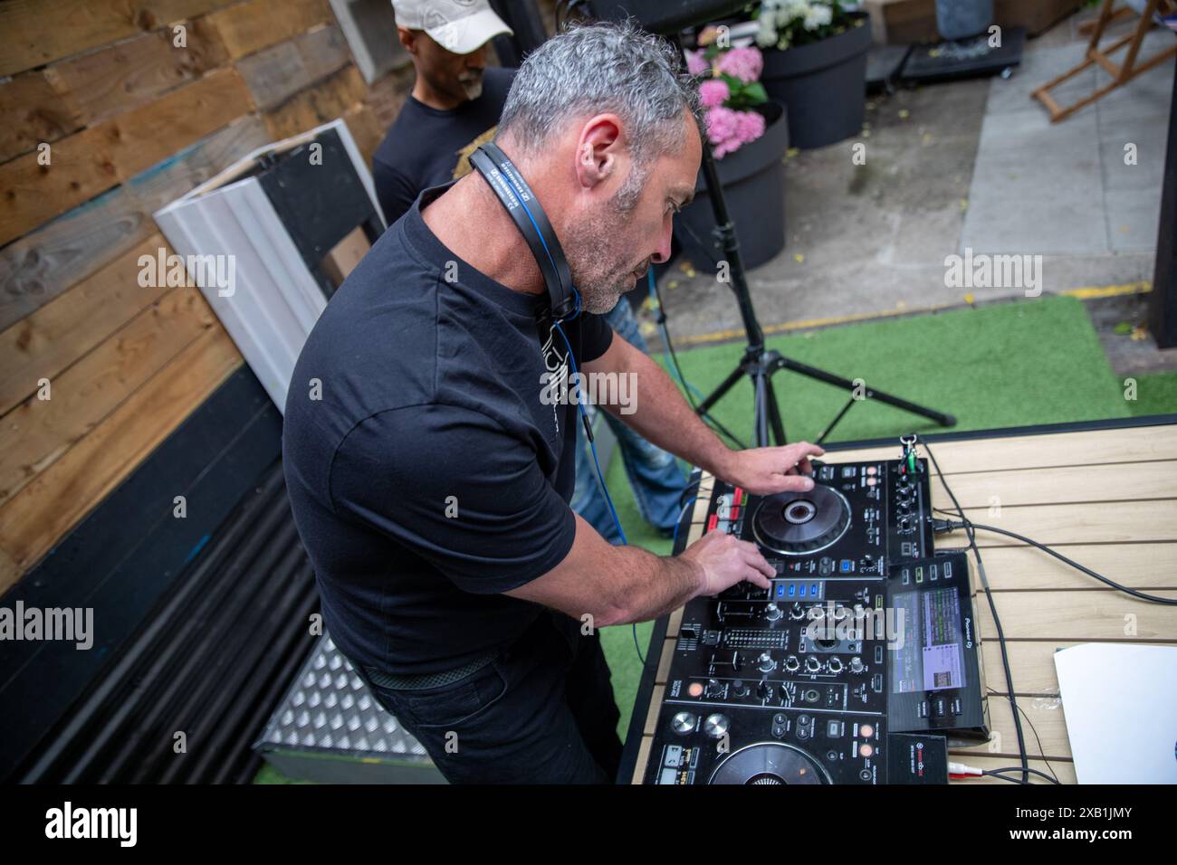 London, UK. 09th June, 2024. DJ Rich Flavours mixes music using ...