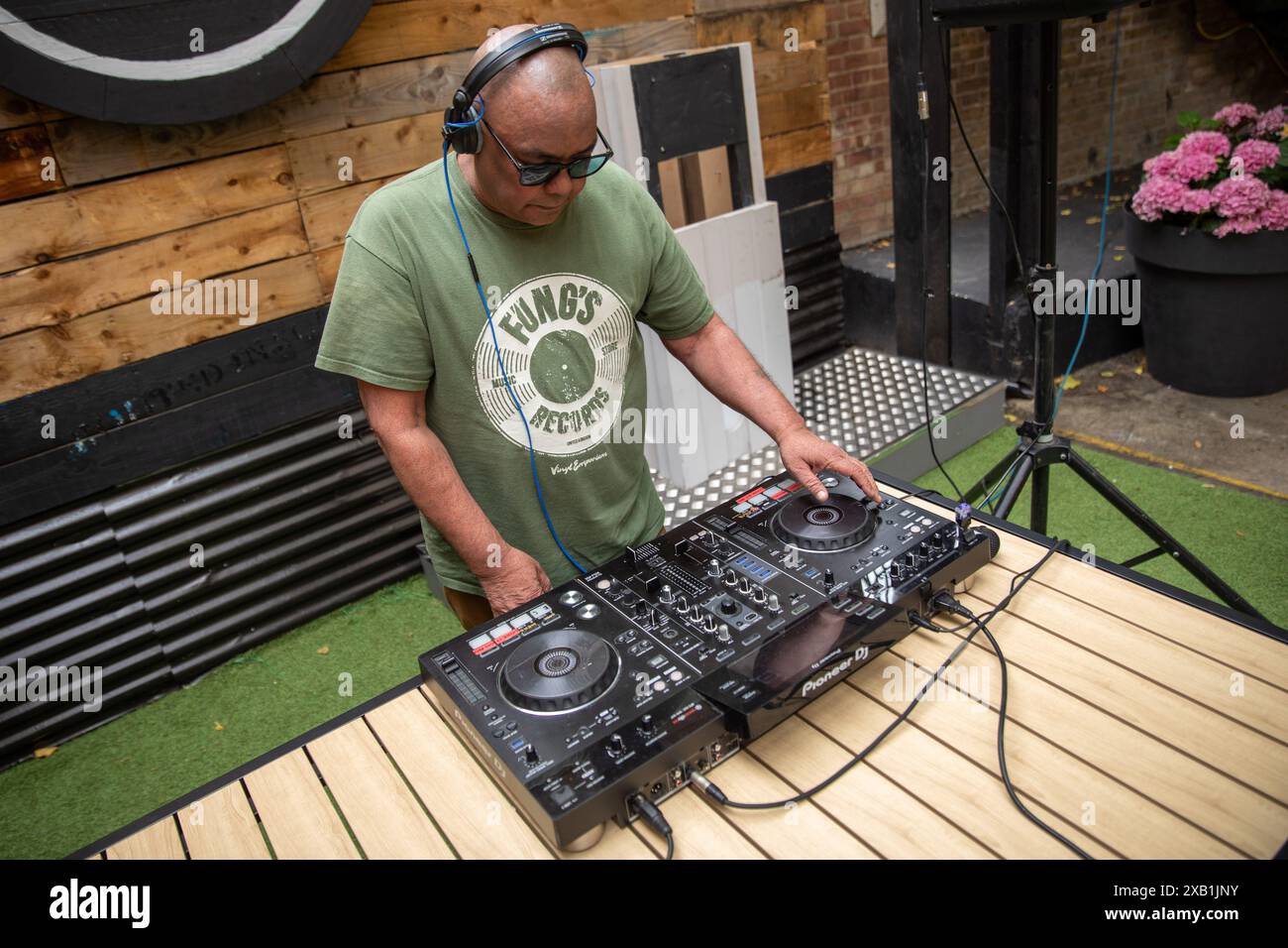 London, UK. 09th June, 2024. DJ Rob Thung stands behind a set of mixing ...