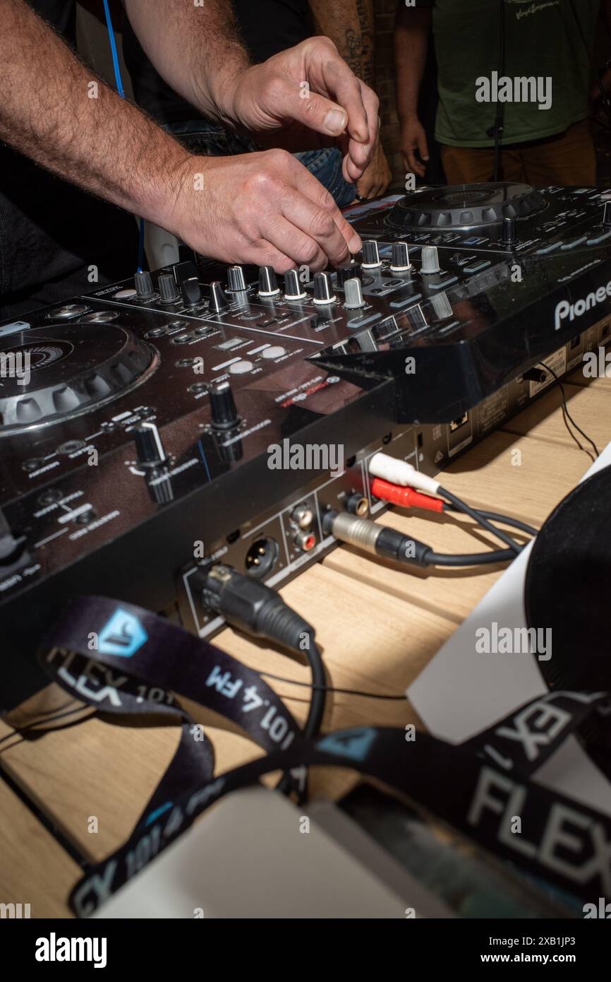 London, UK. 09th June, 2024. A DJ mixes music on a mixing desk. DJs ...