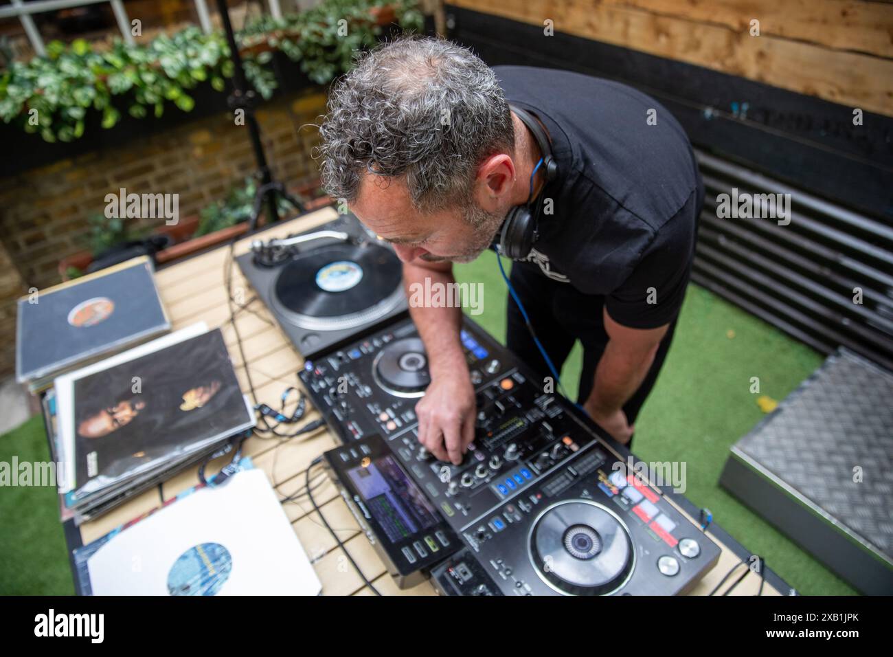London, UK. 09th June, 2024. DJ Rich Flavours leans over a set of ...