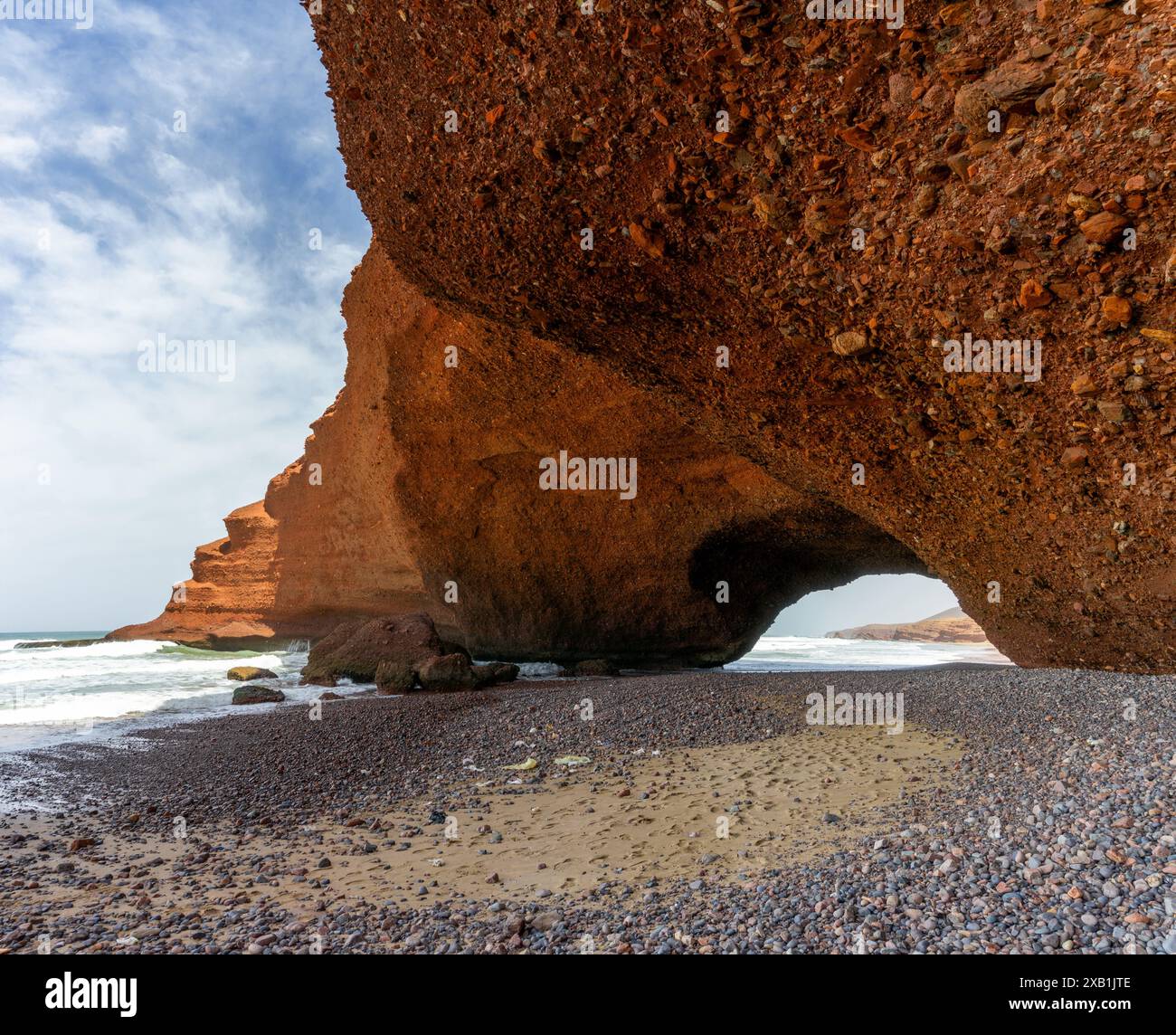 A view of the beach and rock arch at Legzira on the Atlantic Coast of ...