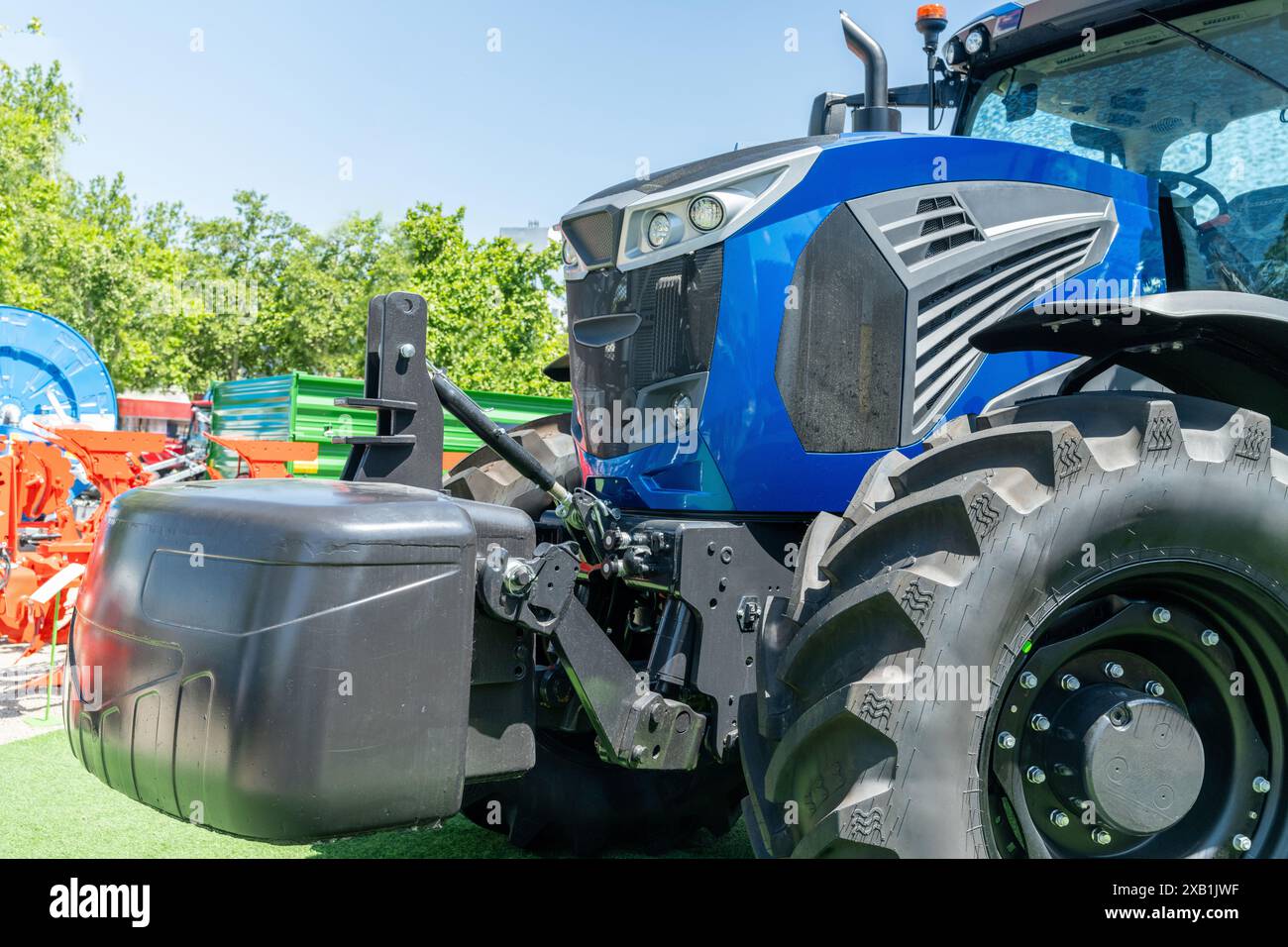 Modern blue agricultural tractor on a field Stock Photo - Alamy