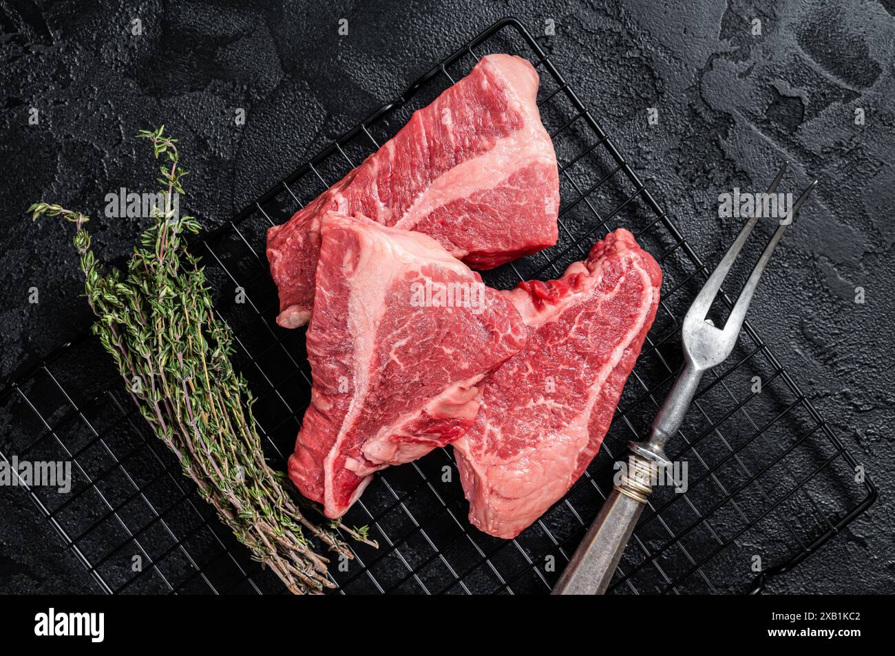 Topside sirloin beef cut, raw meat with spices. Black background. Top ...
