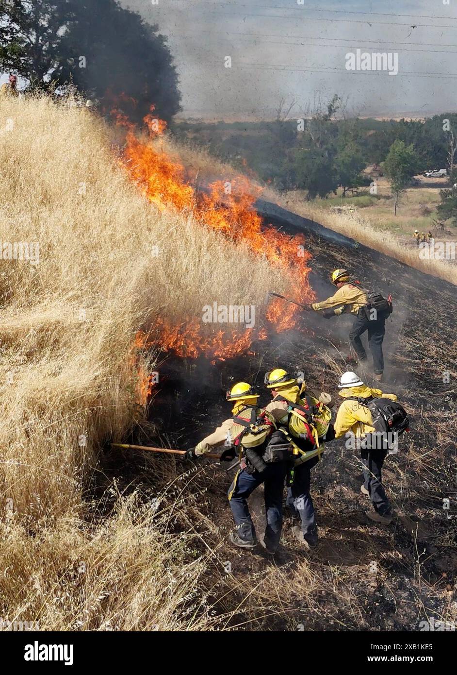 Waterford, Ca, USA. 8th June, 2024. Firefighters use their hand tools ...