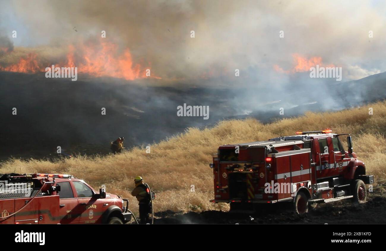 Waterford, Ca, USA. 8th June, 2024. Firefighters work to extinguish a ...