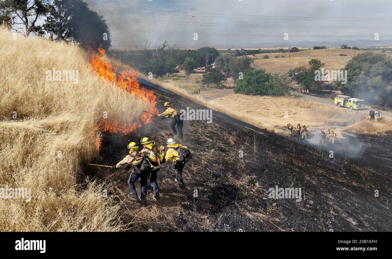 Waterford, Ca, USA. 8th June, 2024. Firefighters use their hand tools ...