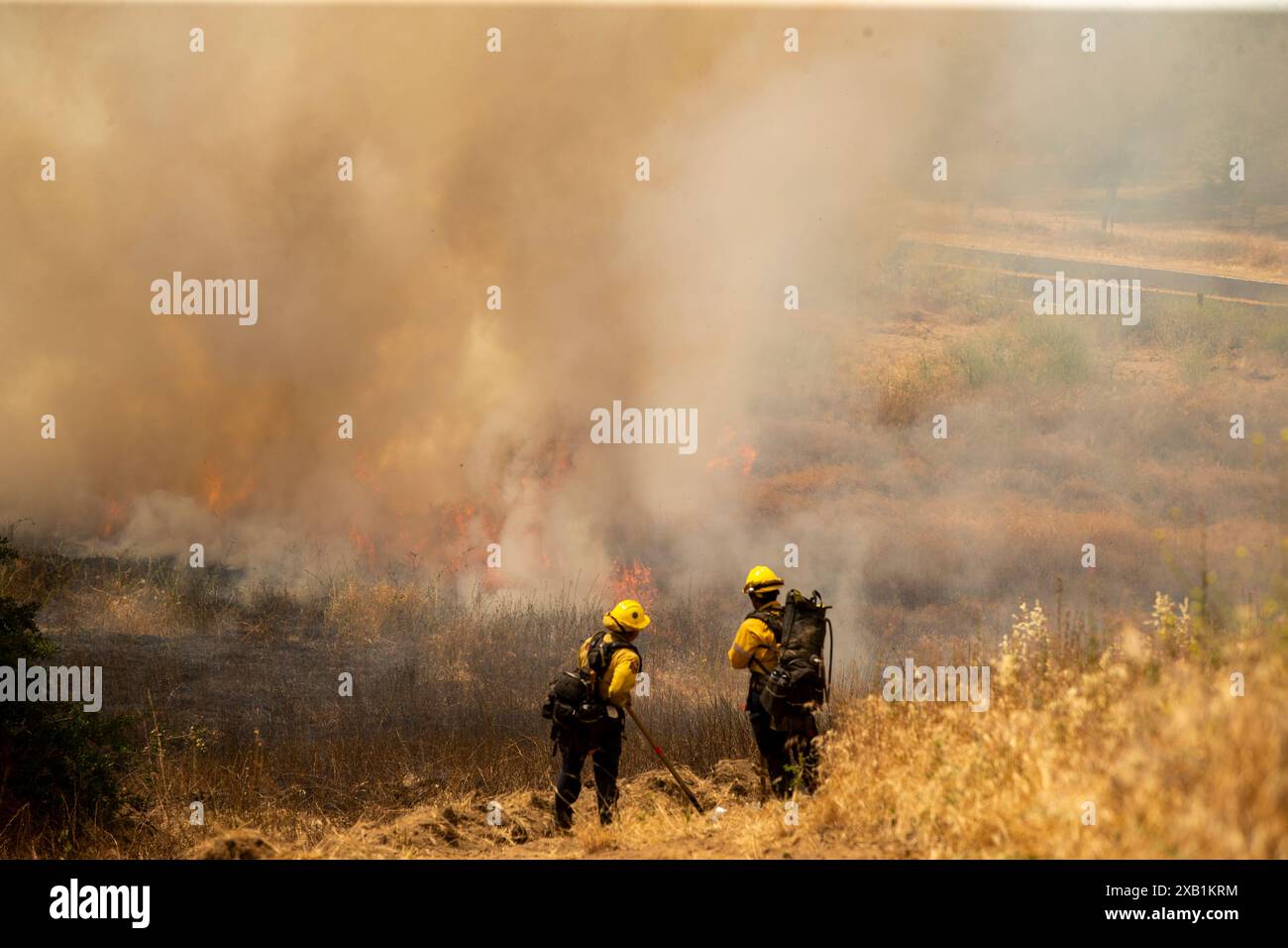 Waterford, Ca, USA. 8th June, 2024. CalFire firefighters watch over a ...