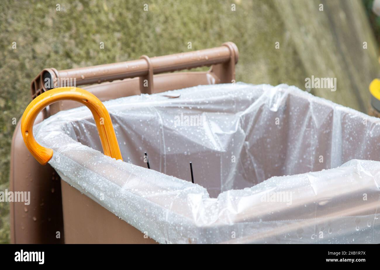 Big plastic rubbish container with opened cover white plastic bag ...