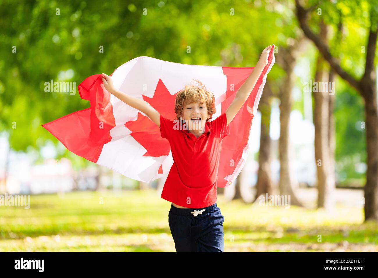 Child with Canadian flag. Happy Canada day. Little boy running with ...