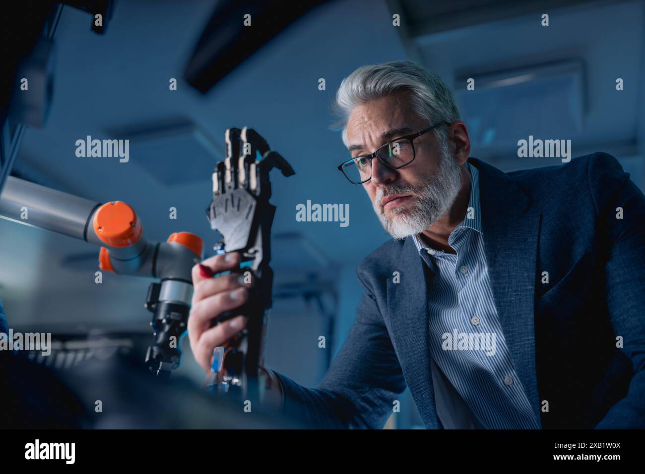 Robotics engineer adjusting, calibring robotic prosthetic hand. Concept ...