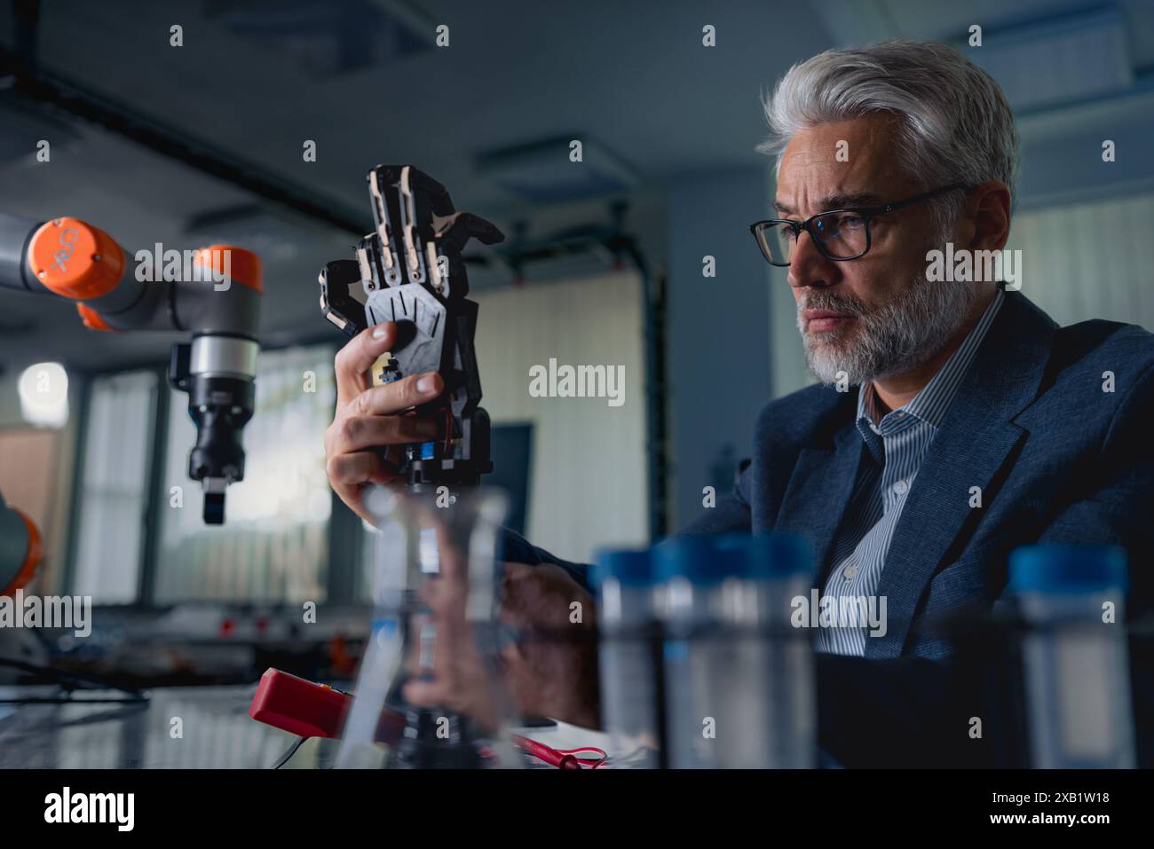 Robotics engineer adjusting, calibring robotic prosthetic hand. Concept ...